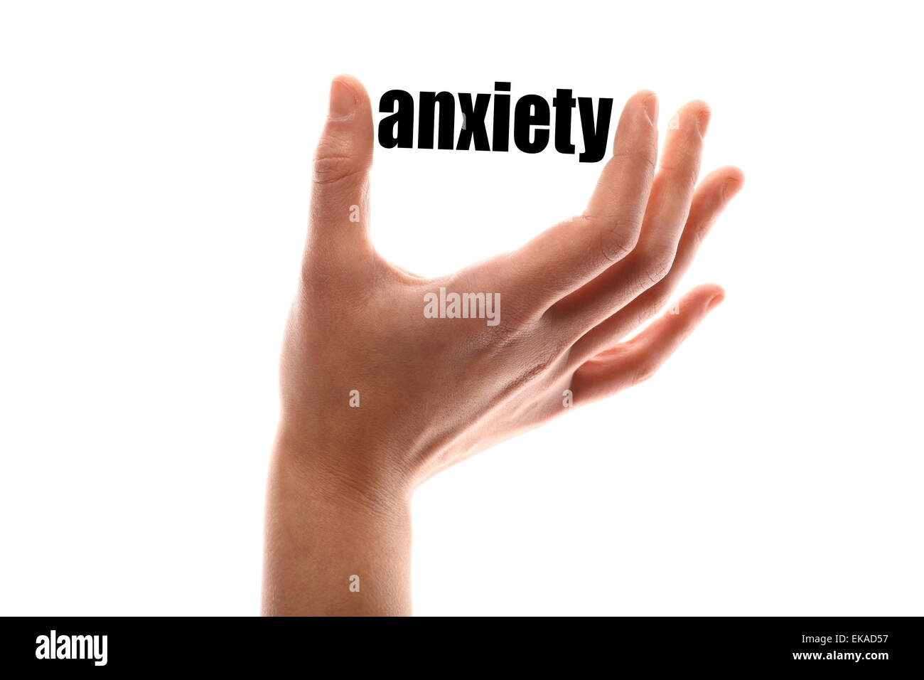 Color horizontal shot of a hand holding the word "anxiety" between two ...