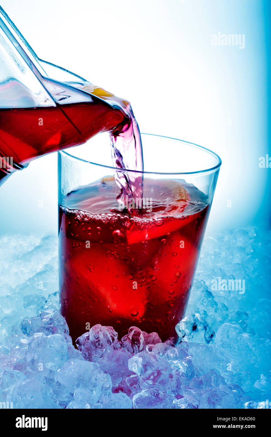 closeup of a glass with typical spanish sangria being filled from a ...