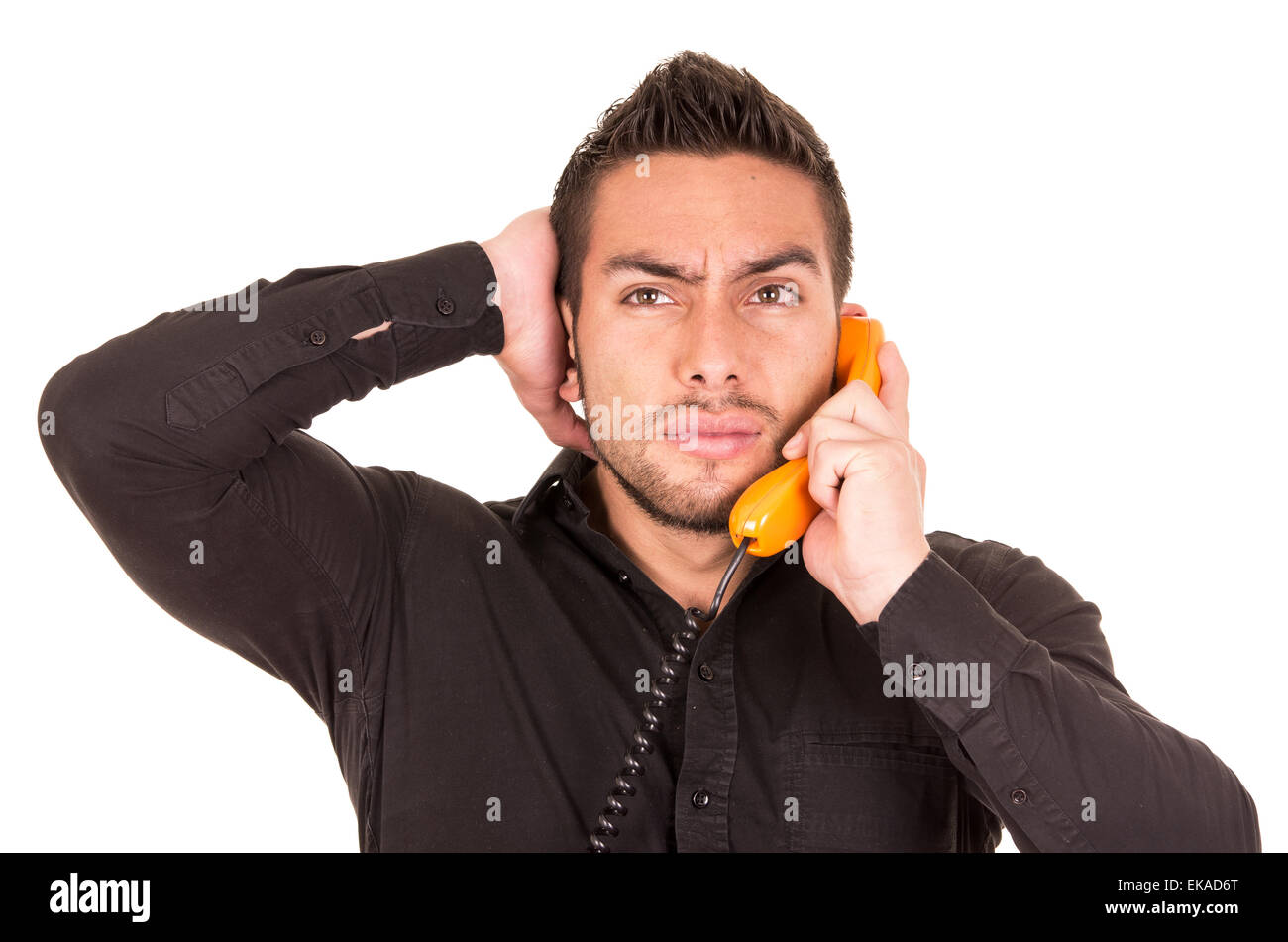 closeup portrait of handsome hispanic man talking on corded retro phone ...