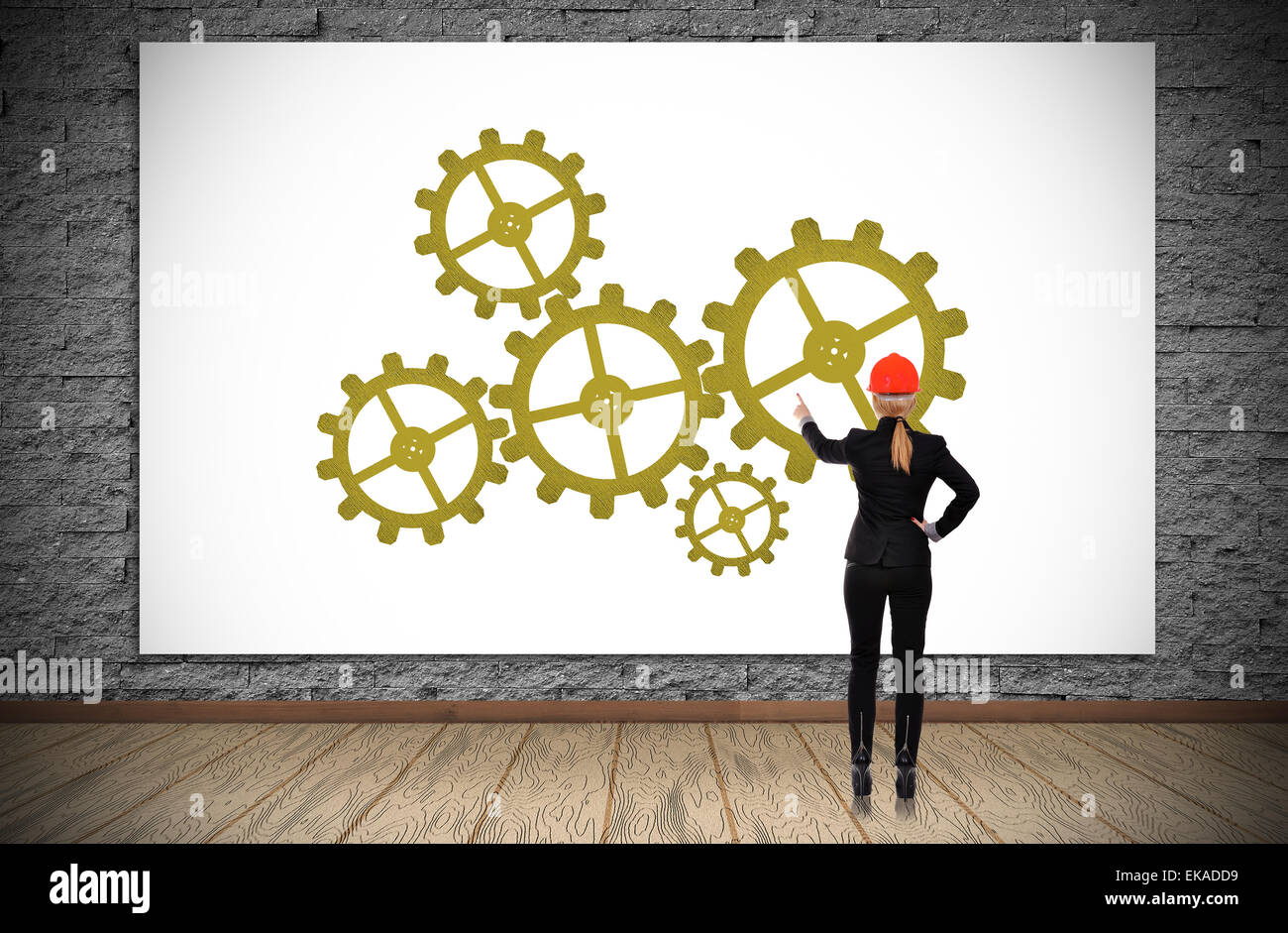 engineer woman pointing to placard with yellow cogs and gears Stock ...
