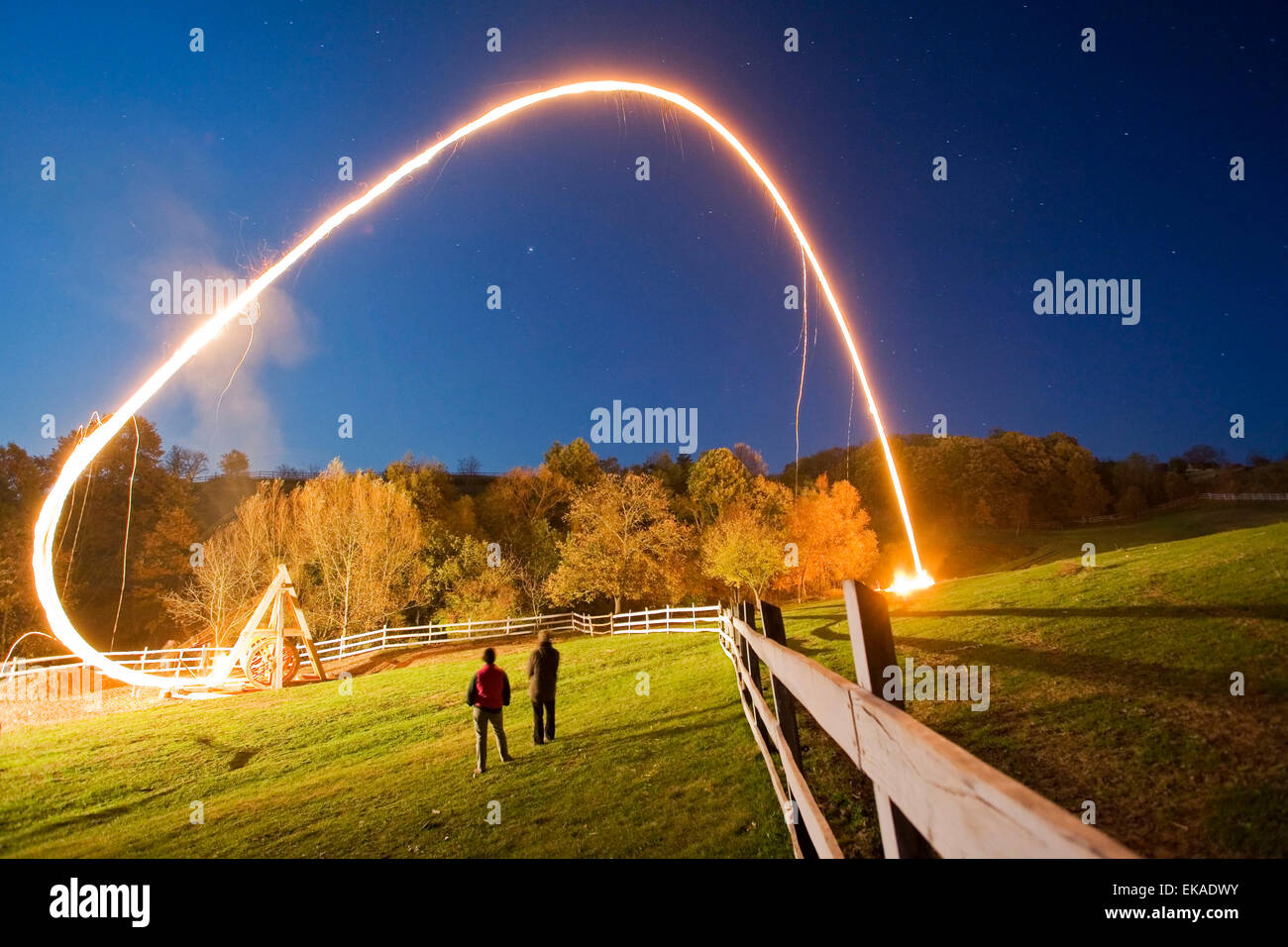 long exposure image of a catapult with a fireball at night Stock Photo ...