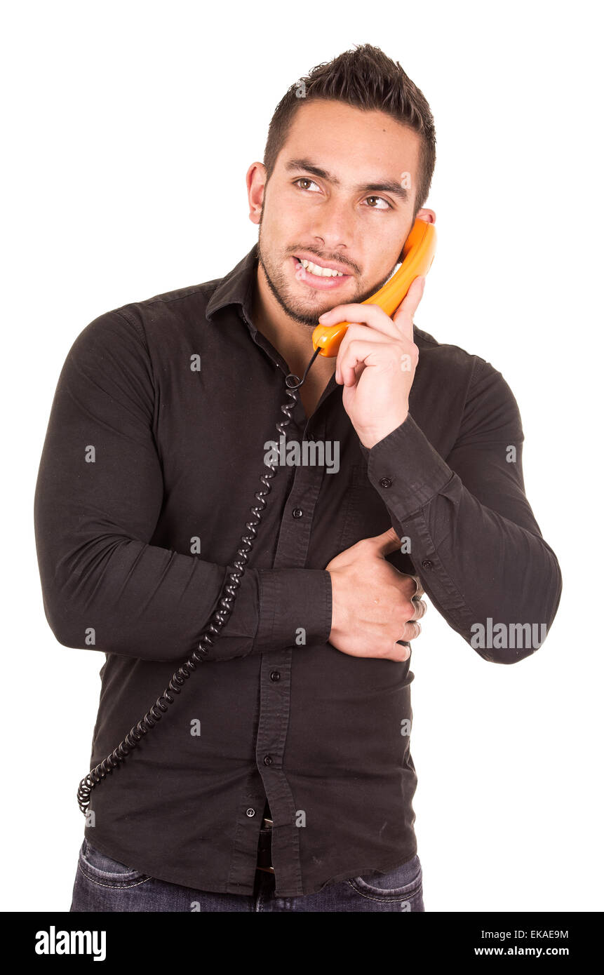 closeup portrait of handsome hispanic man talking on corded retro phone ...