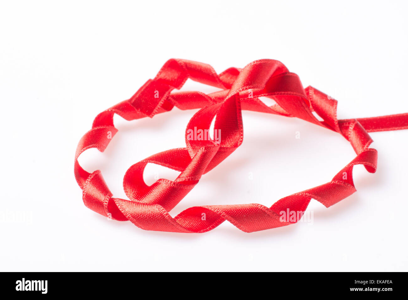 Red silk twisted ribbon in the form Stock Photo - Alamy