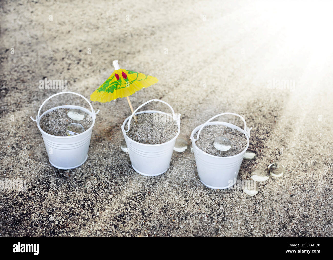 Little white buckets full of sand on the sandy beach. Summer holiday ...