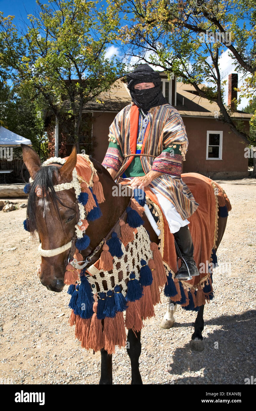 Dressed in colorful period garb, Danny SalDaNa rides his arabian horse ...