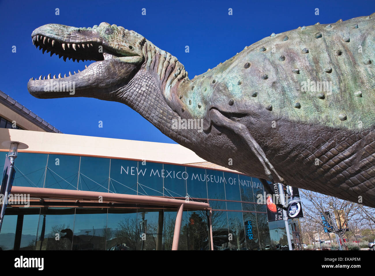 A giant green skinned raptor greets visitors at the entrance to the New ...