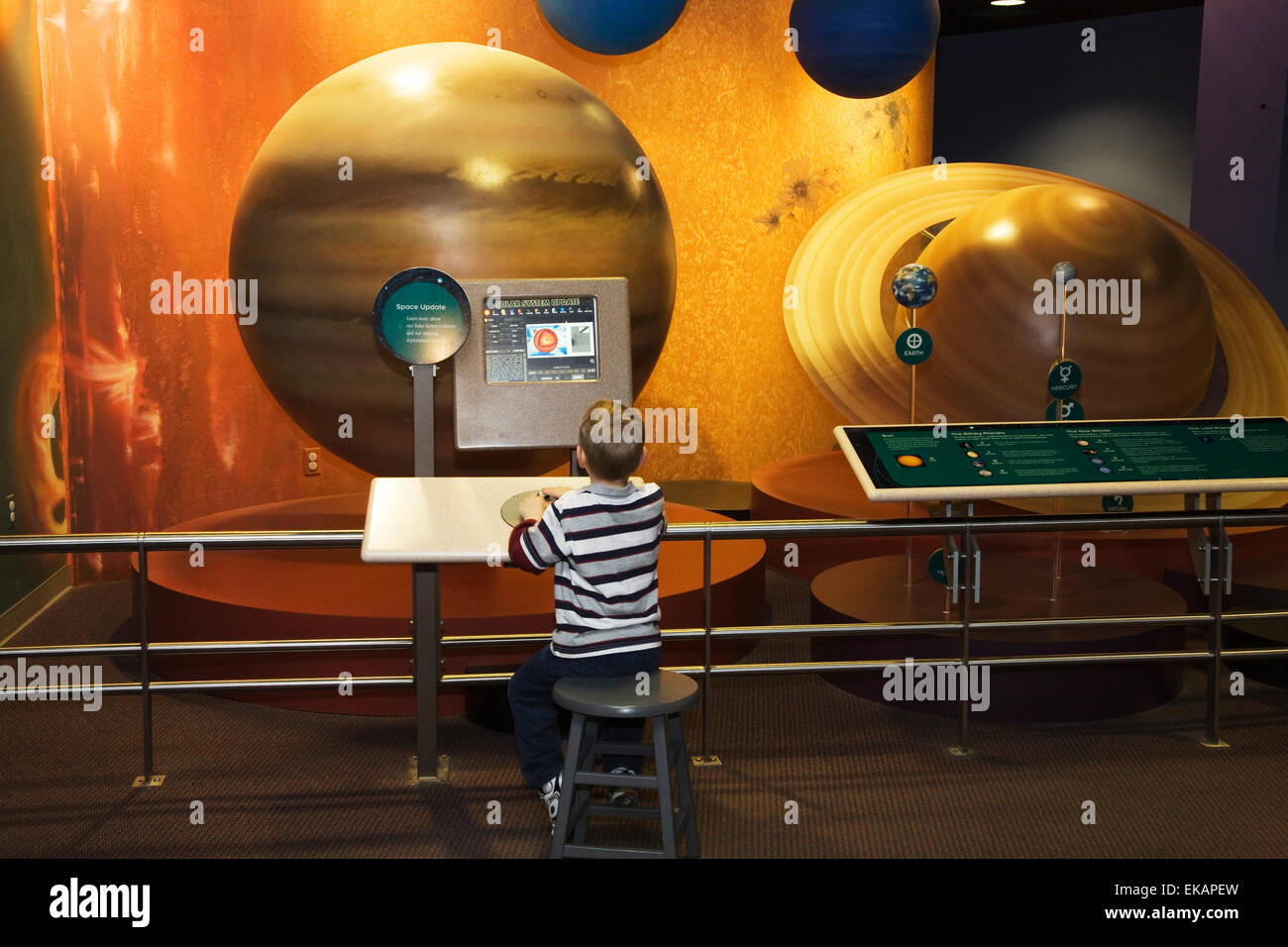 A young visitor learns about the planets at the Museum of Natural ...