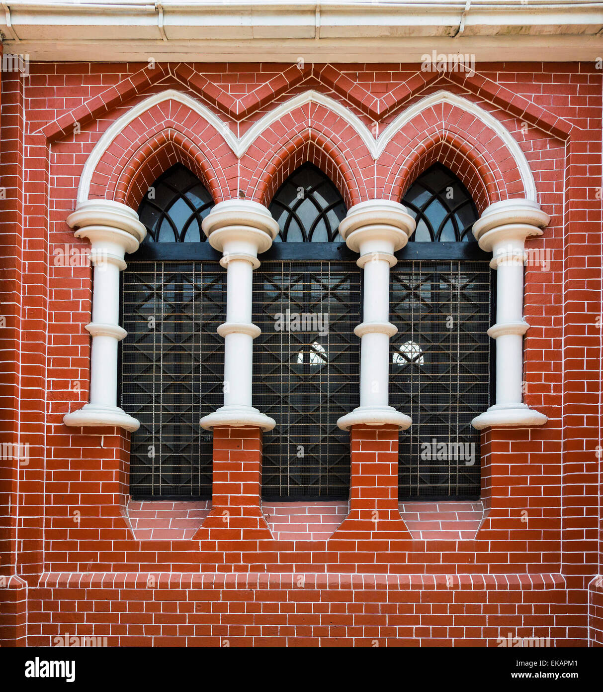 Red brick wall and stained glass window in Holy trinity Cathedral in ...