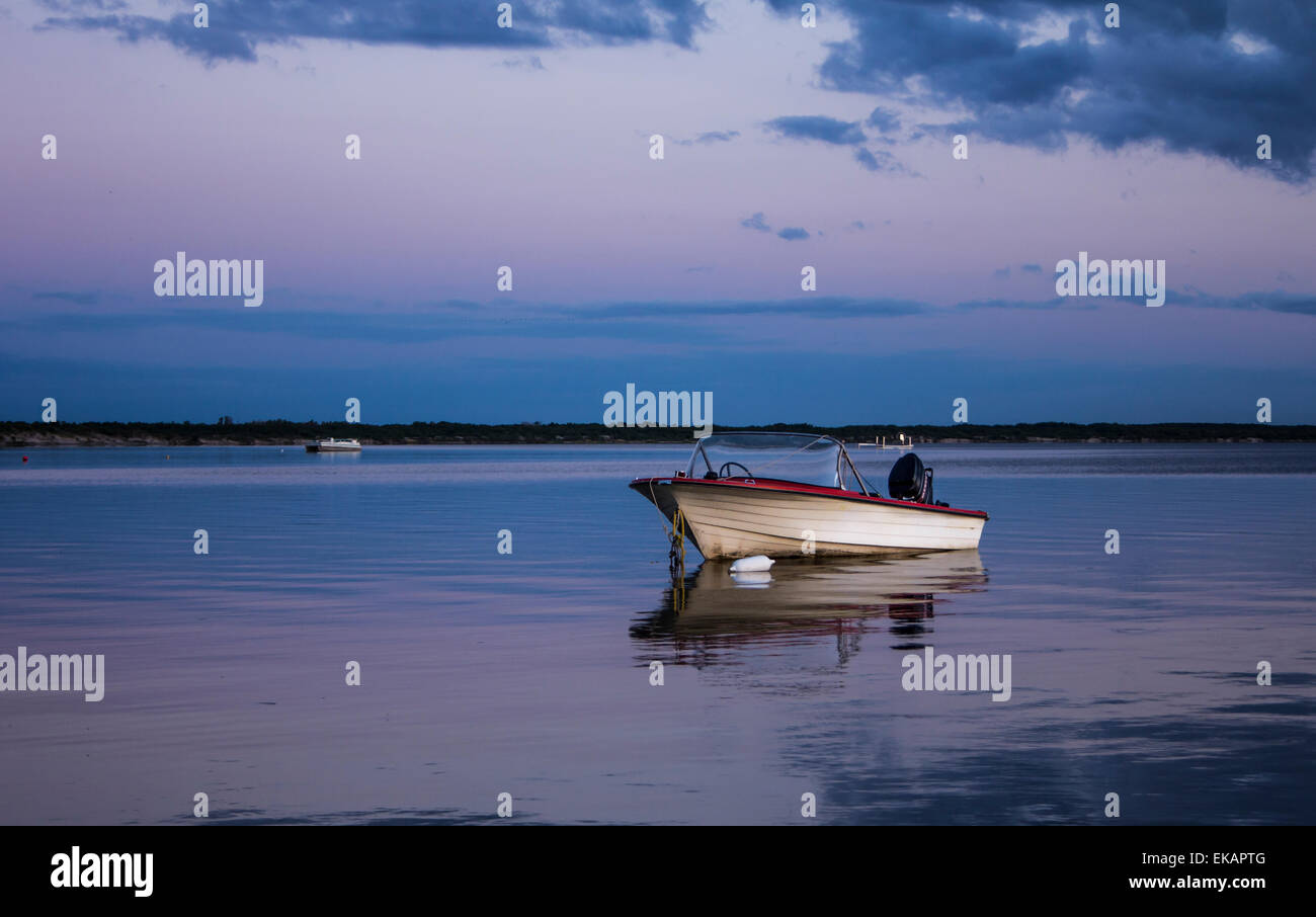 Fishing boat in the sunrise on a calm still morning on the lake Stock ...