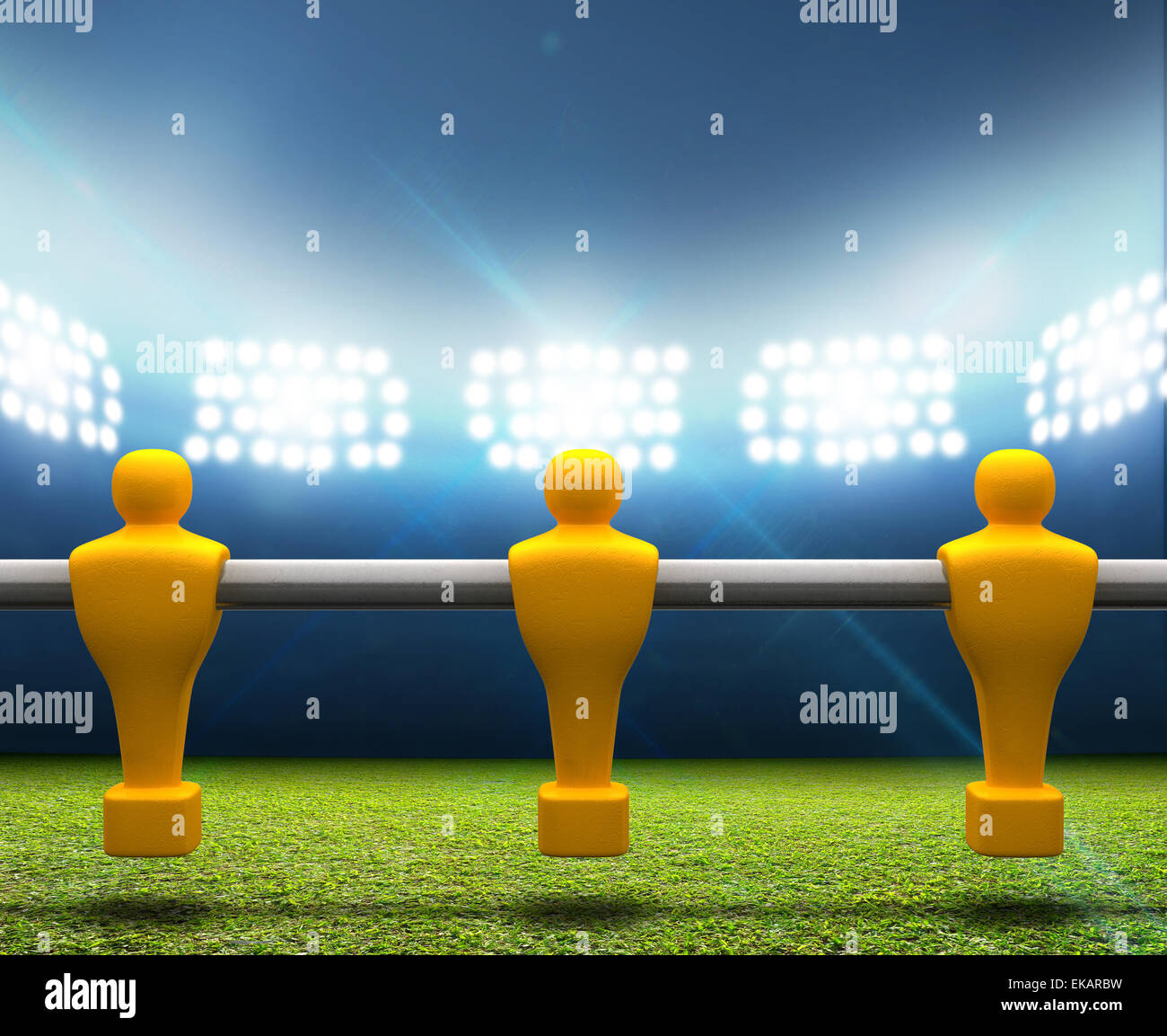 A football stadium with an unmarked green grass pitch and a row of ...