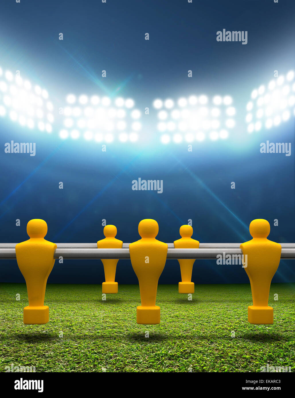 A football stadium with an unmarked green grass pitch and a row of ...