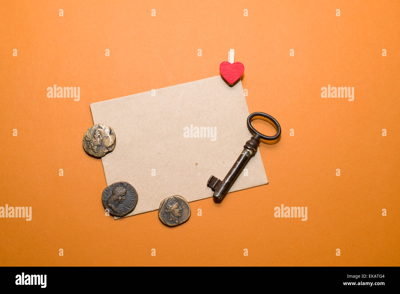 Vintage coins, old key and envelope on orange background Stock Photo ...