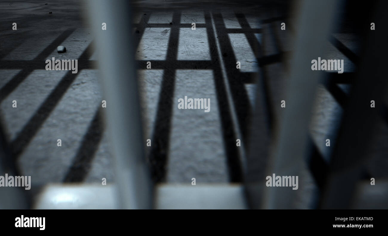 A closeup of view of a jail cells iron bars casting shadows on the prison floor with copy space ...