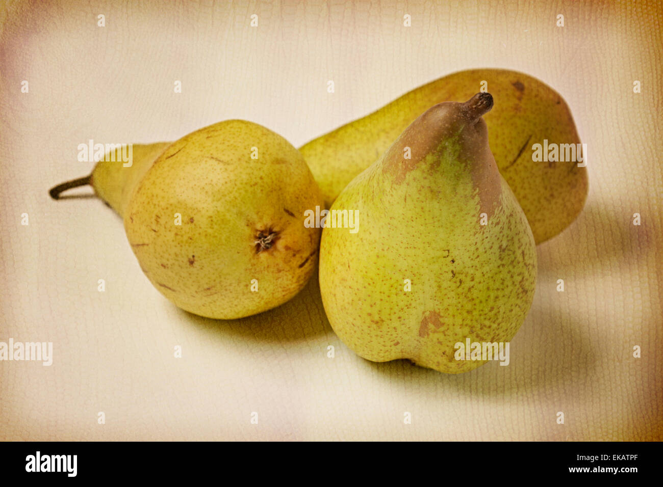 Three pears on a kitchen table Stock Photo - Alamy