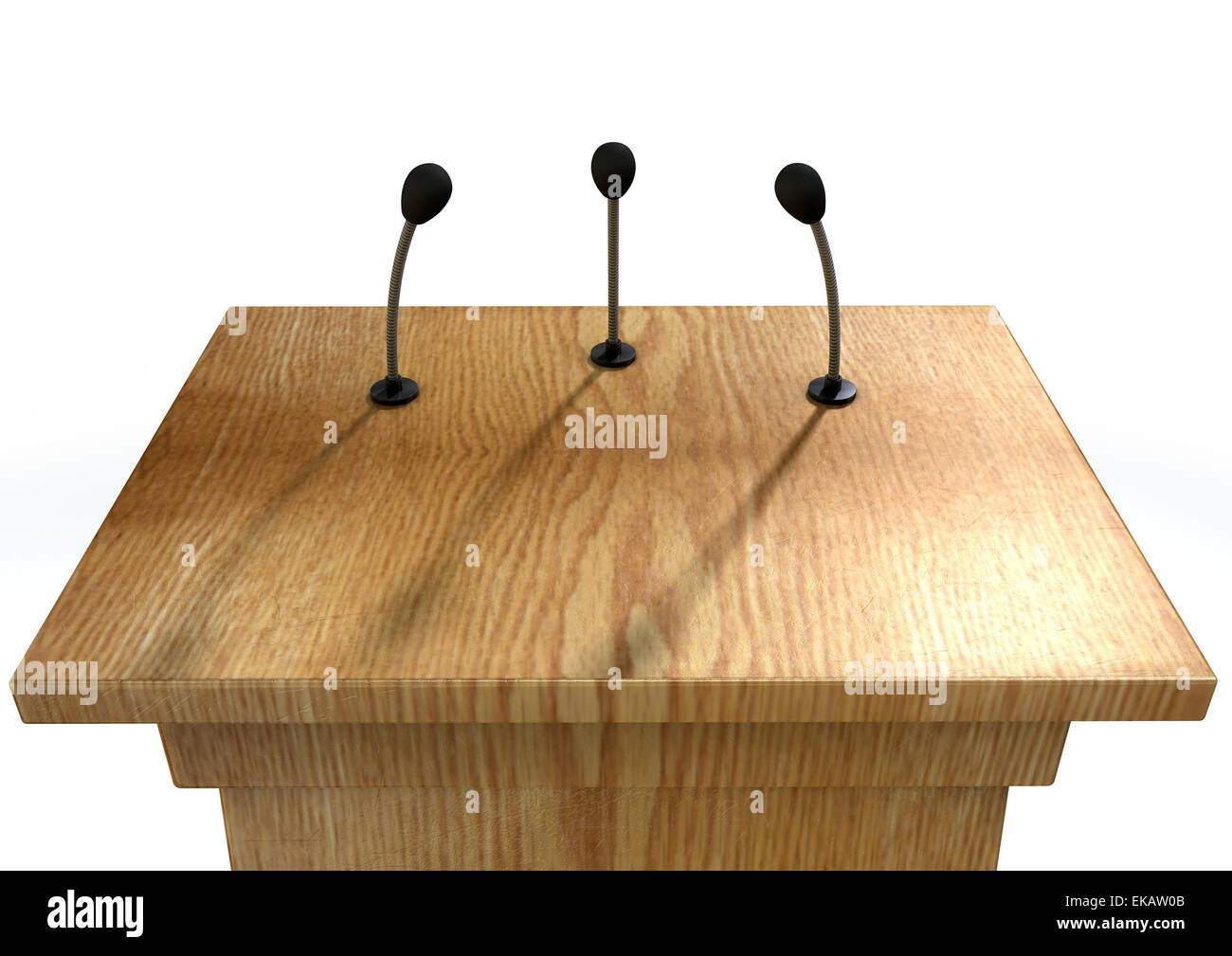A wooden speech podium with three small microphones attached on an ...