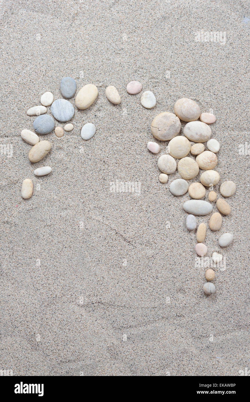 few stones on beach sand with a bright background Stock Photo - Alamy