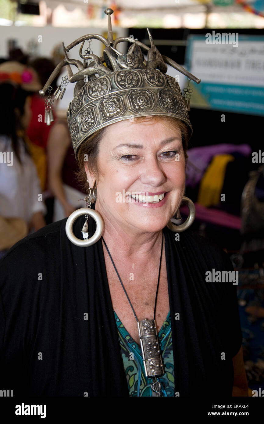 Sharon Shaffer, a visitor to the Santa Fe International Folk Art Market, tries on a colorful ...