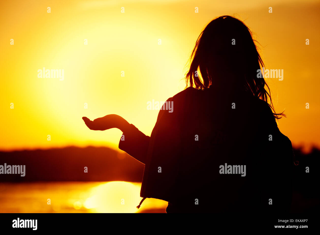 little girl holding in hands the setting sun Stock Photo - Alamy