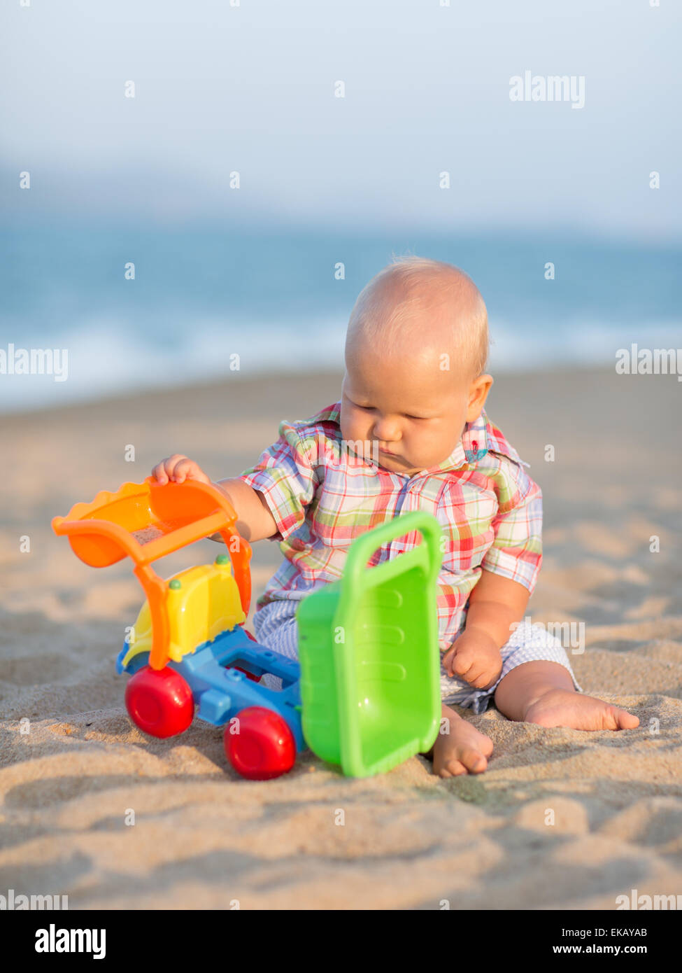 Cute baby is playing toy car Stock Photo - Alamy