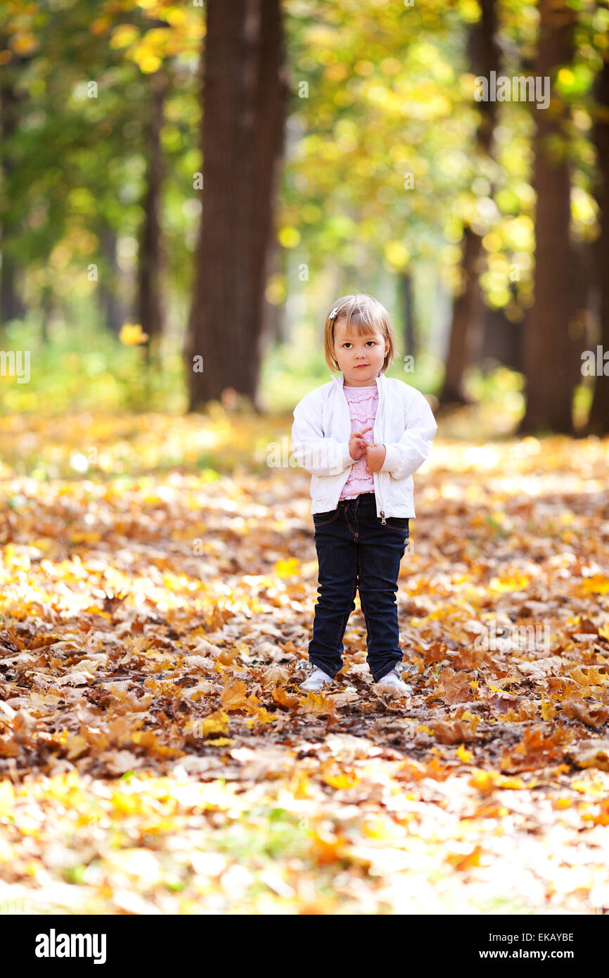 beautiful little girl in the autumn forest Stock Photo - Alamy