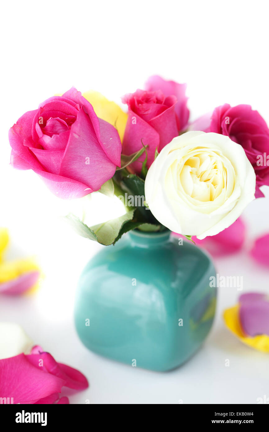 bouquet of colorful roses in vase and petals Stock Photo - Alamy