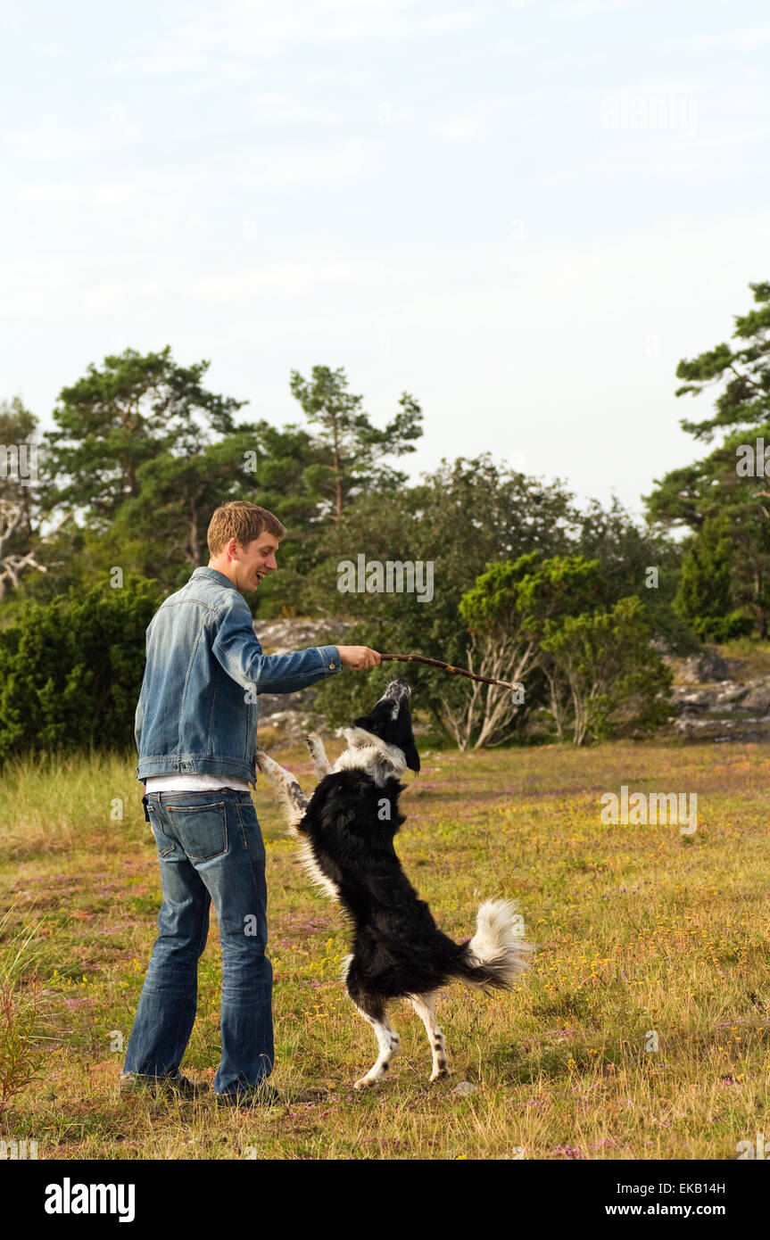 man playing with his dog outdoors Stock Photo - Alamy