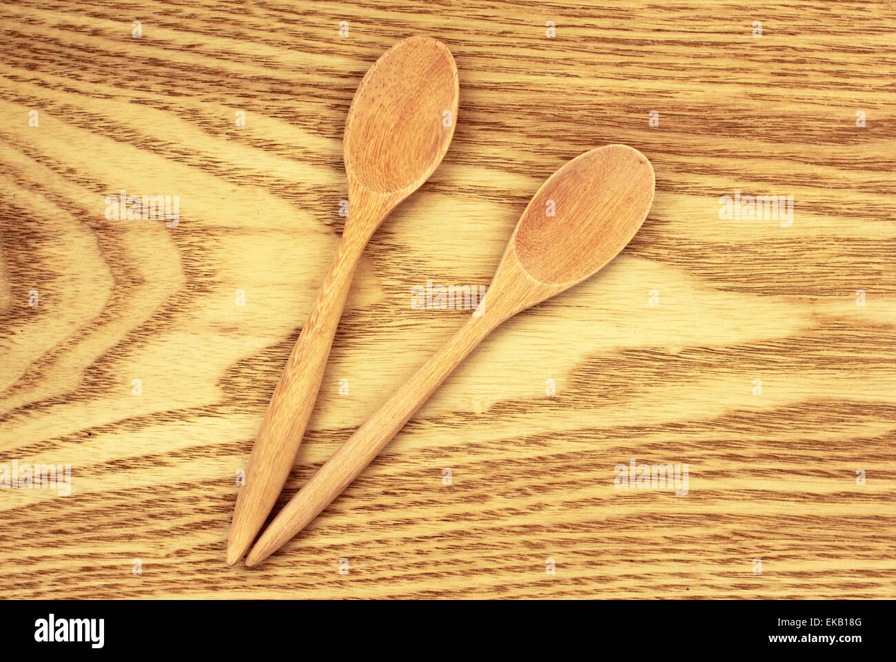 Two wooden spoons on table Stock Photo - Alamy