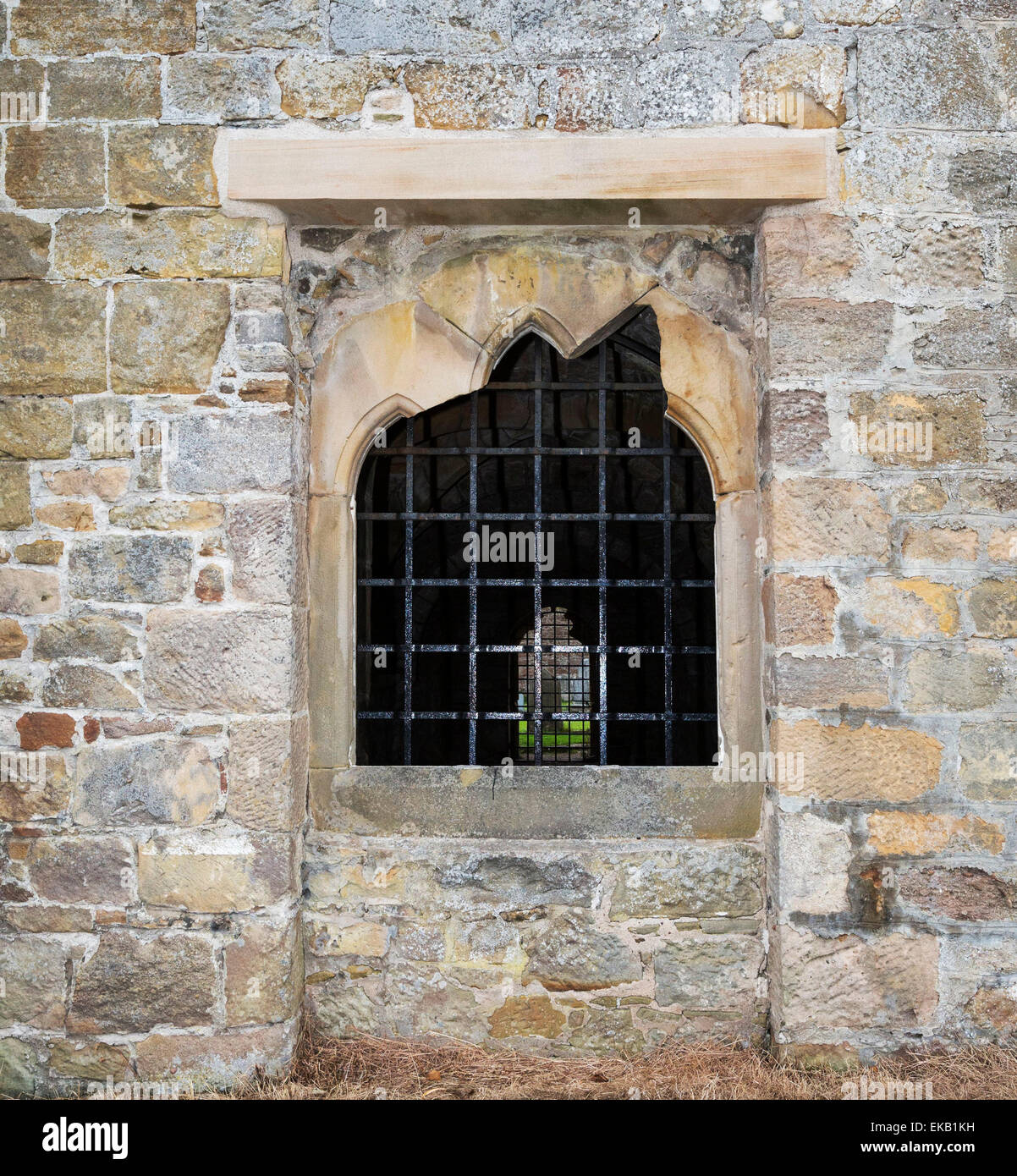 Stone window with bars in England Stock Photo - Alamy