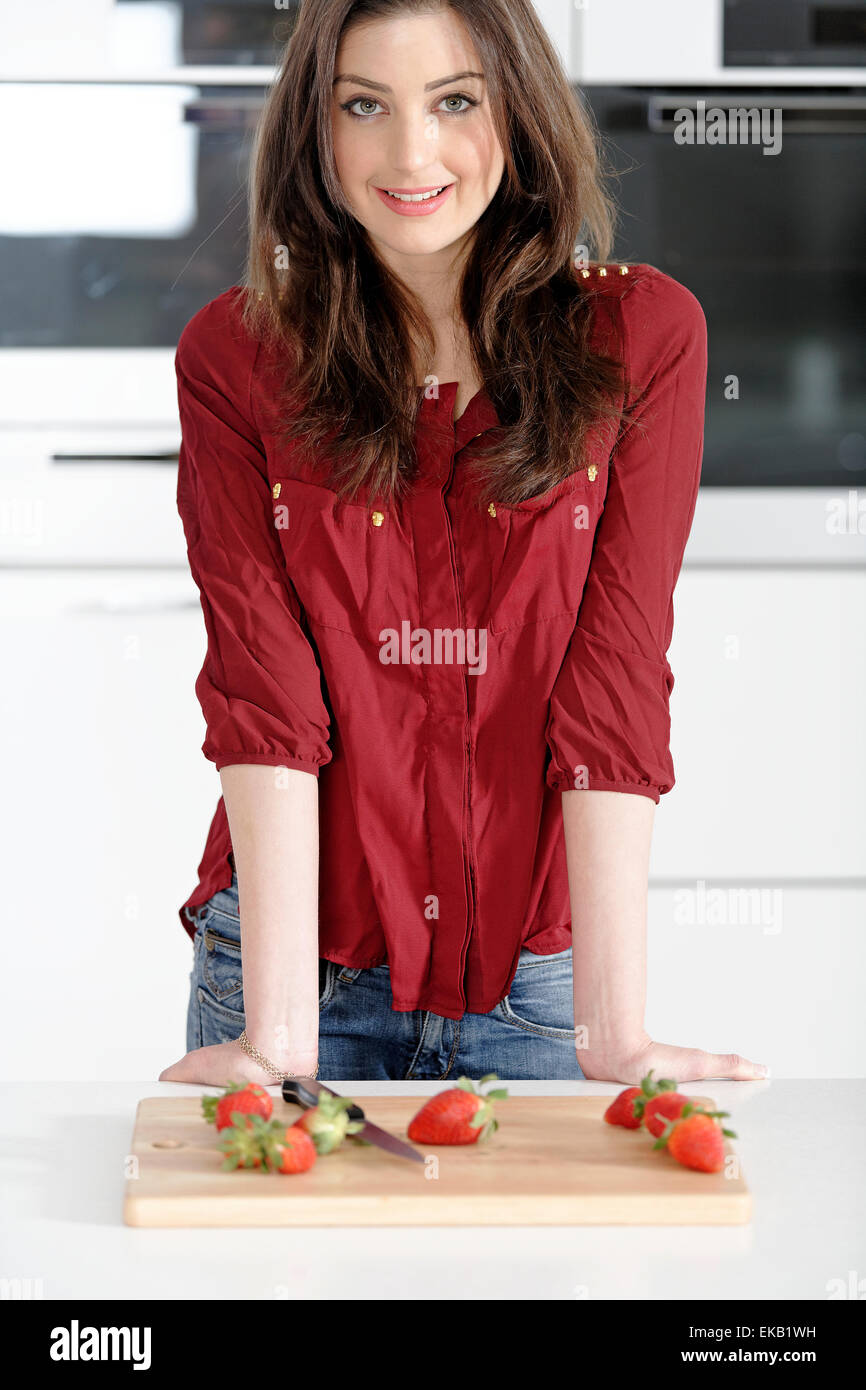 Woman cutting up fruit Stock Photo - Alamy