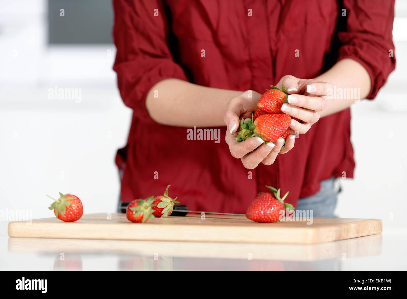 Woman cutting up fruit Stock Photo - Alamy