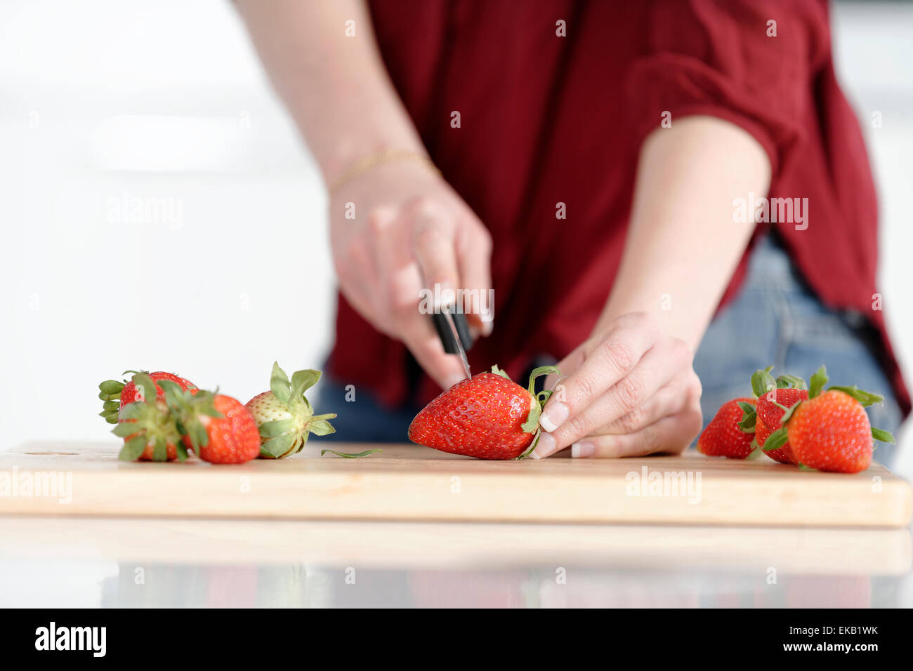 Woman cutting up fruit Stock Photo - Alamy