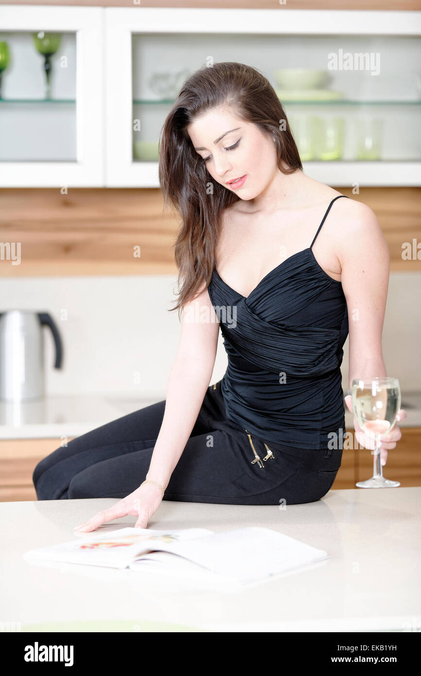 Woman reading recipe book Stock Photo - Alamy
