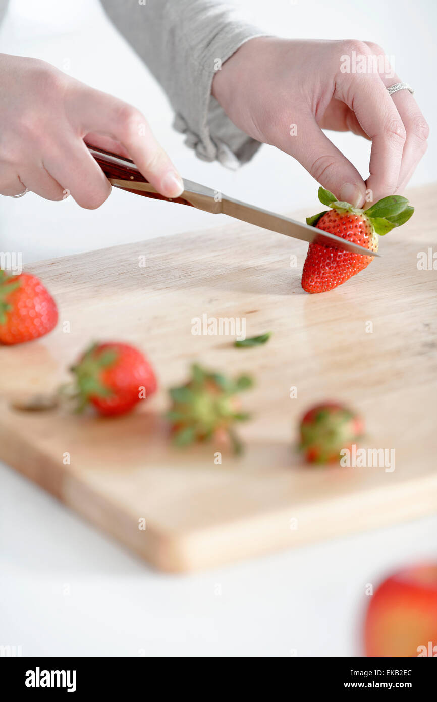 Woman cutting up fruit Stock Photo - Alamy