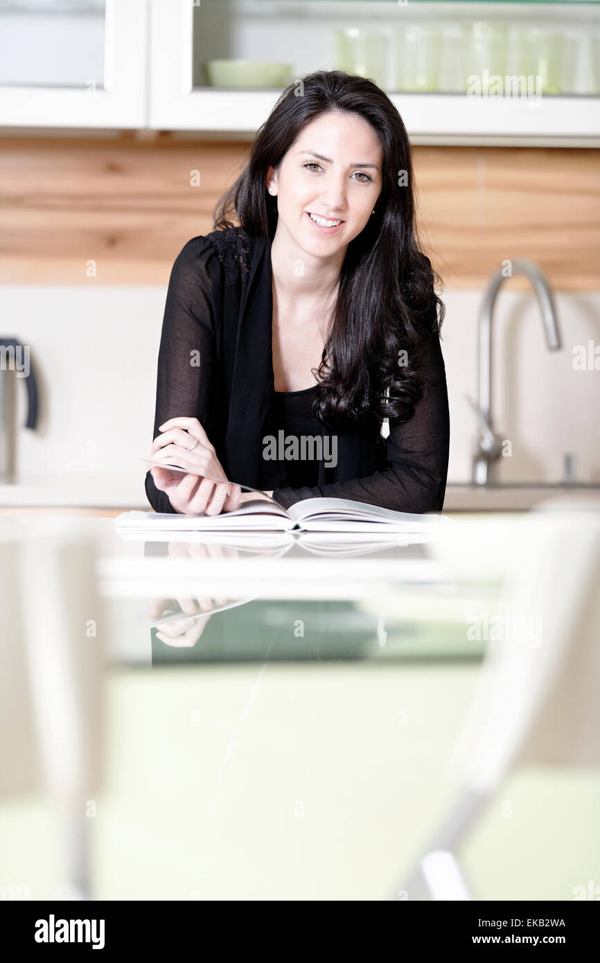 Woman reading recipe book Stock Photo - Alamy