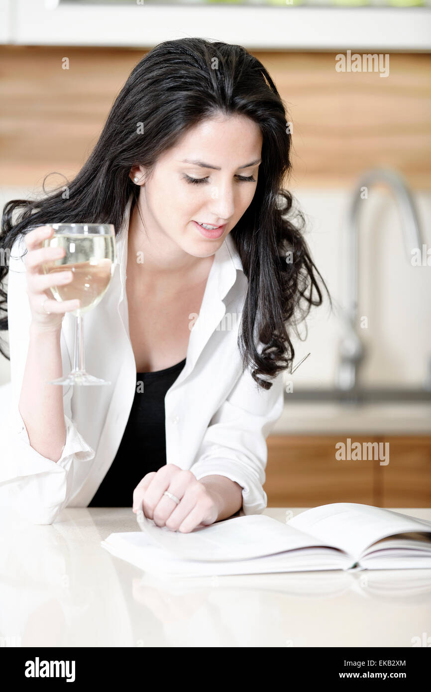 Woman reading recipe book Stock Photo - Alamy