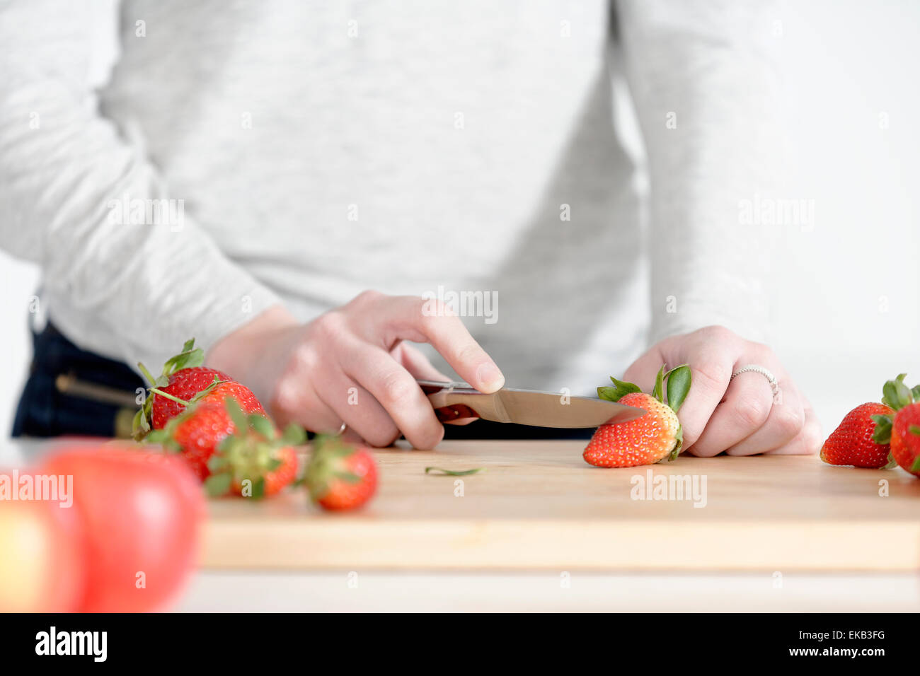 Woman cutting up fruit Stock Photo - Alamy