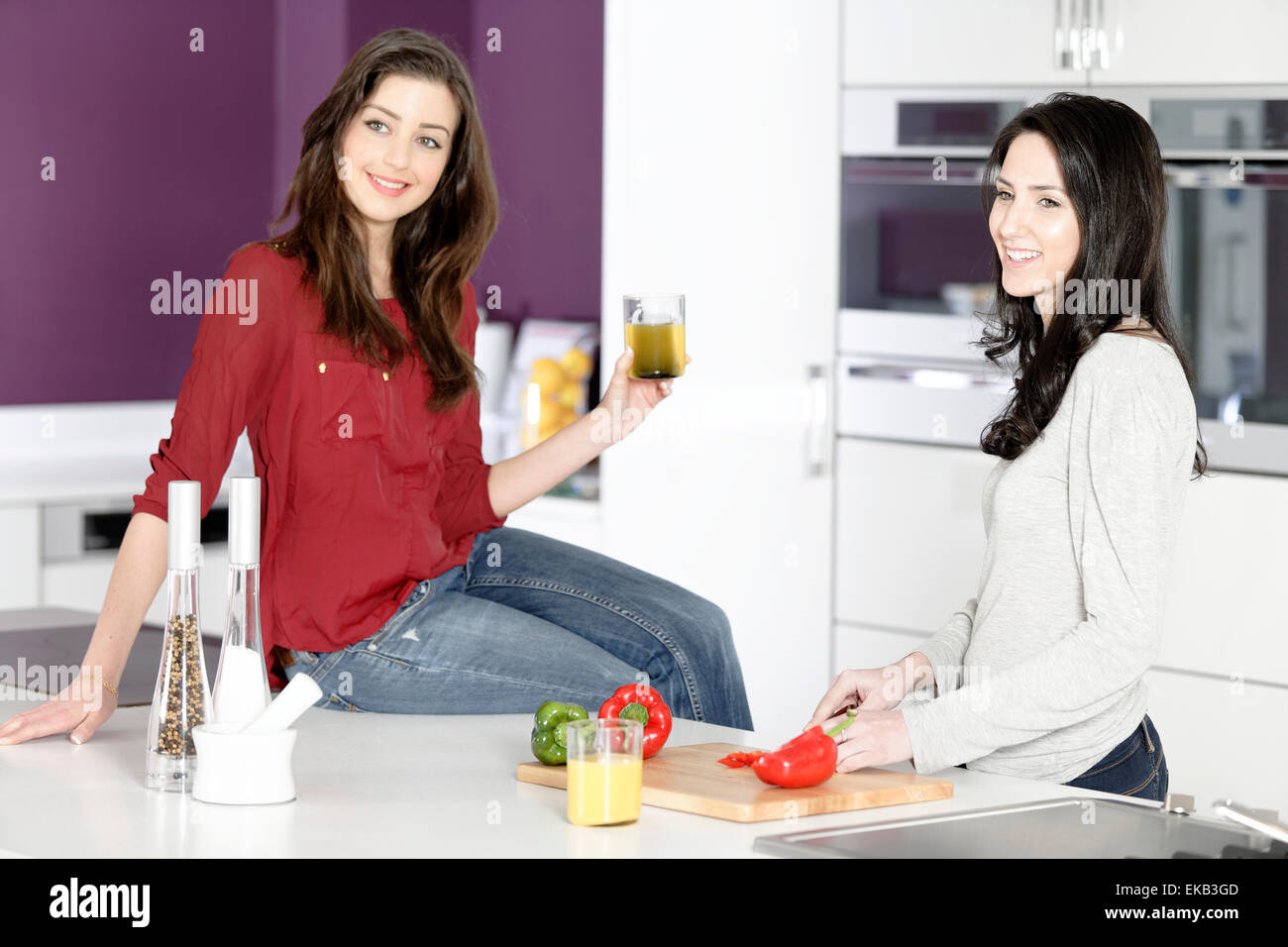 Two friends preparing food Stock Photo - Alamy
