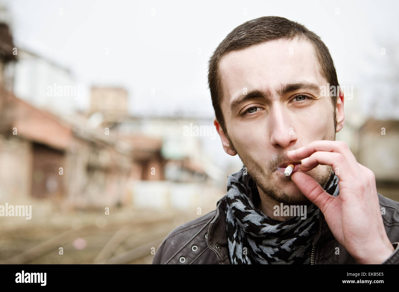 Portrait of handsome smoking young man Stock Photo - Alamy