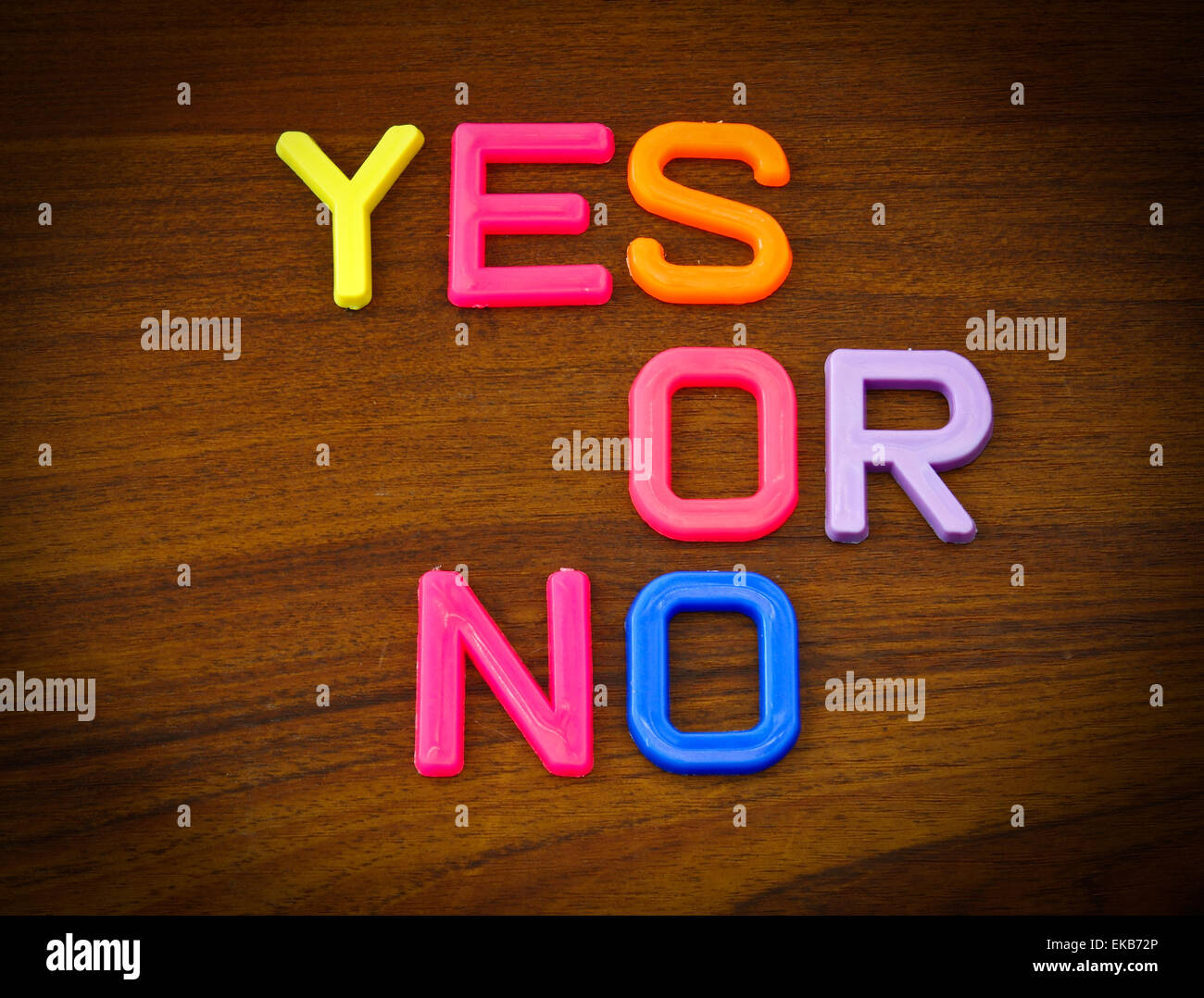 Yes or no in colorful toy letters on wood background Stock Photo - Alamy