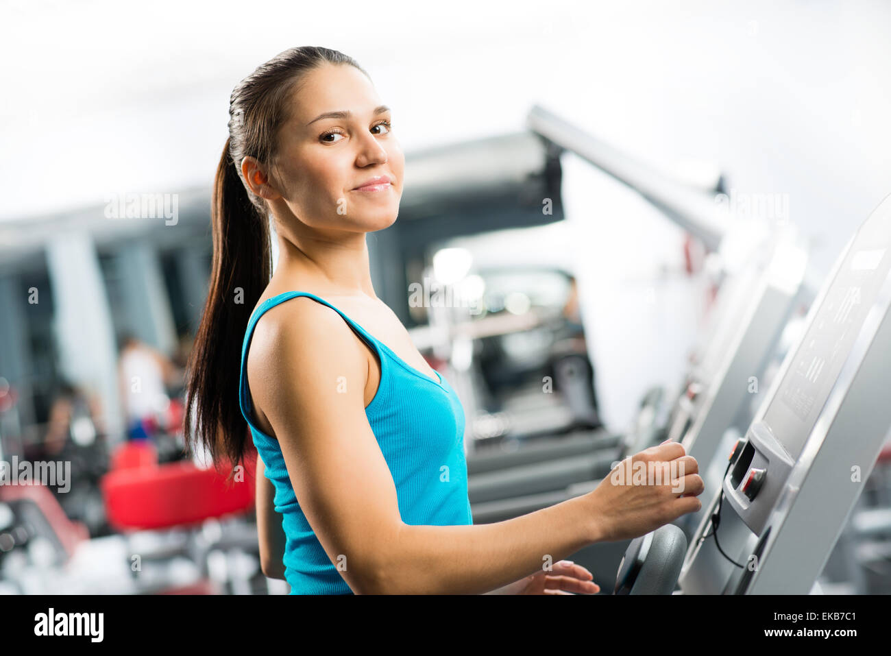 attractive young woman runs on a treadmill Stock Photo - Alamy