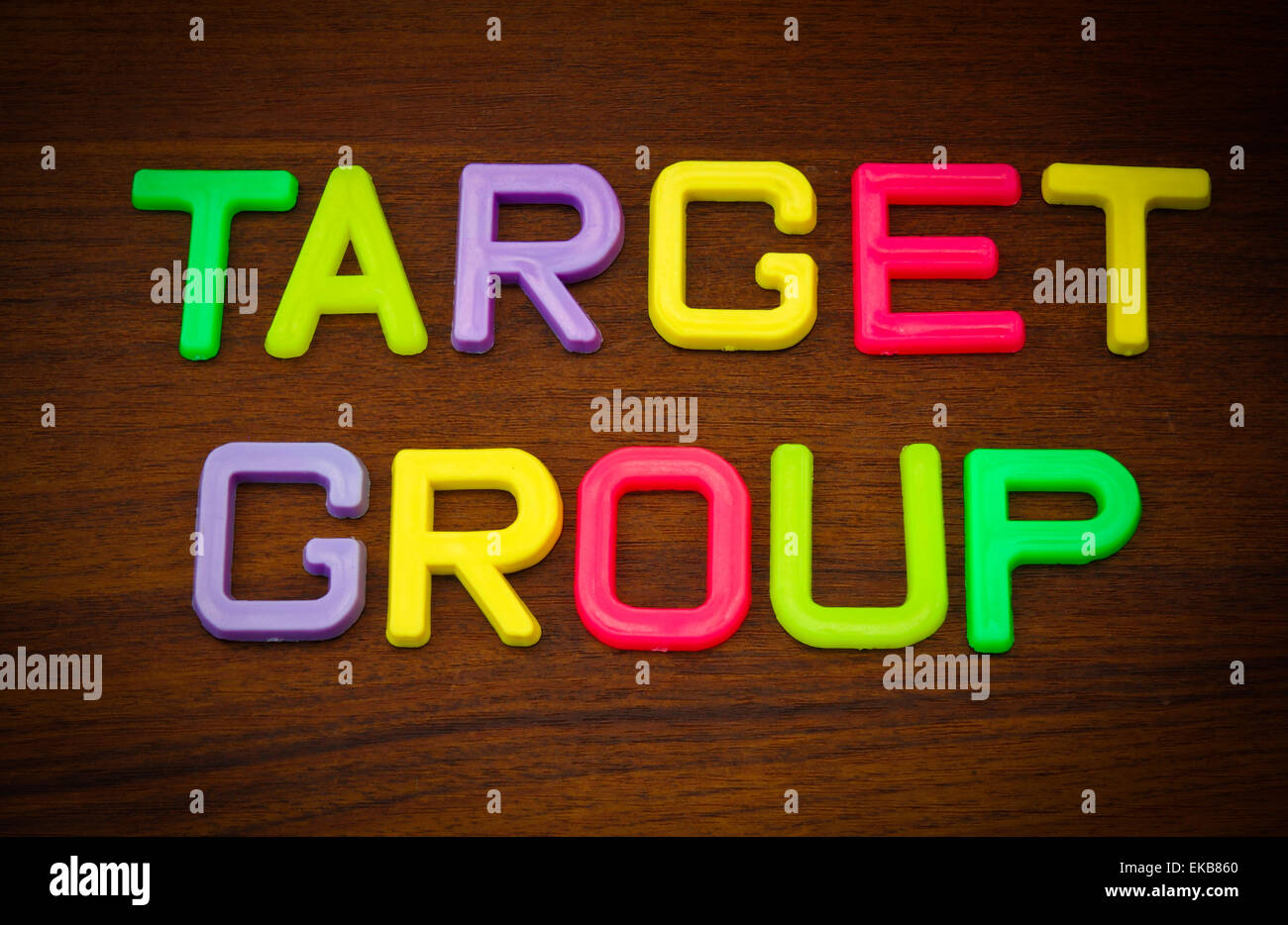 Target group in colorful toy letters on wood background Stock Photo - Alamy