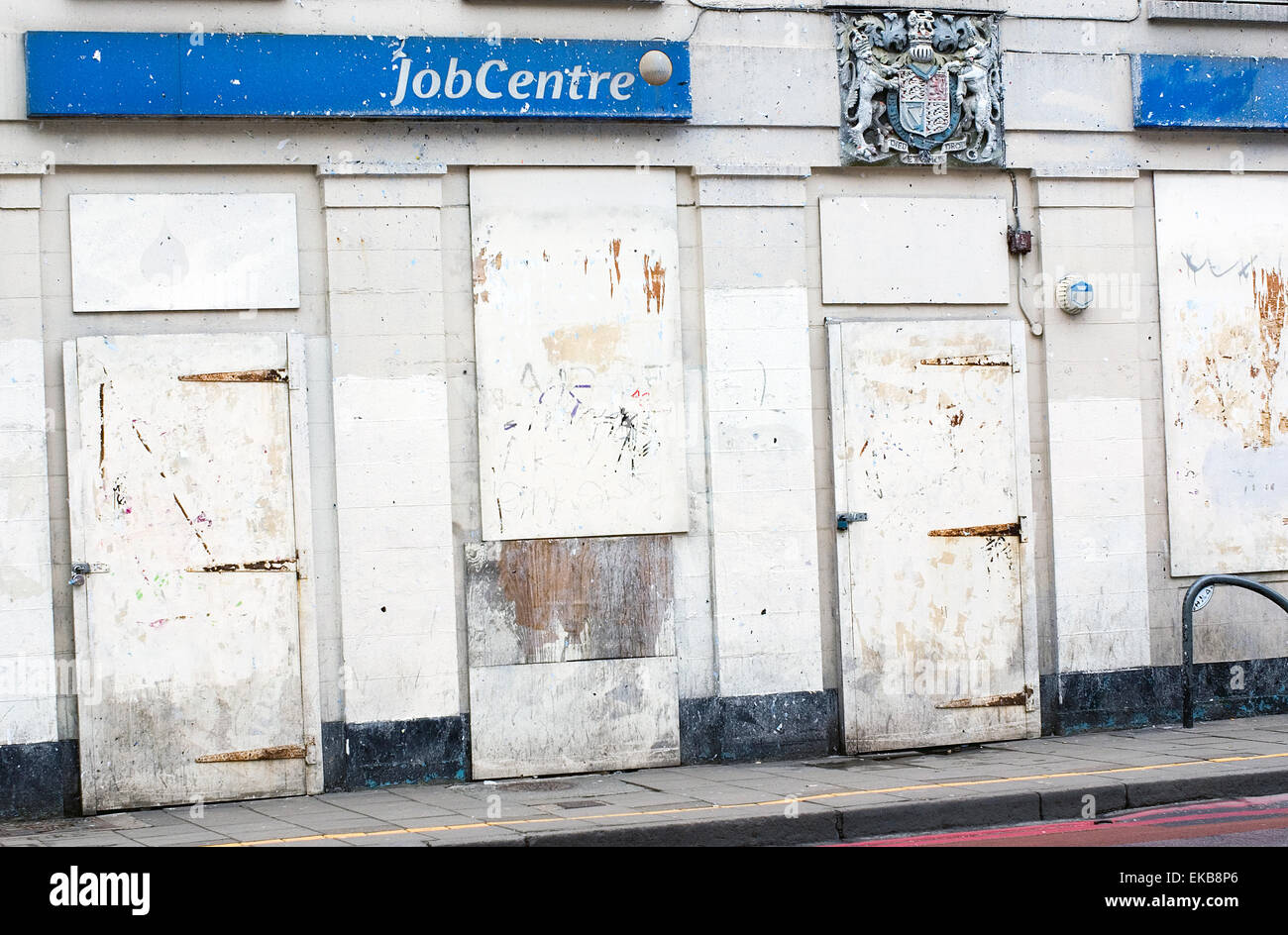 jobcentre office closed and boarded up doors and window, indicative of ...