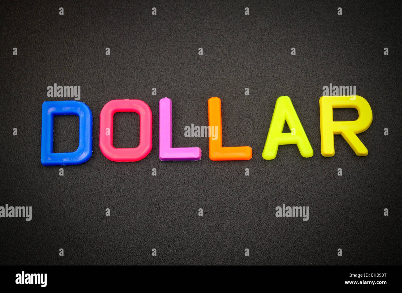 Dollar in colorful toy letters on black background Stock Photo - Alamy