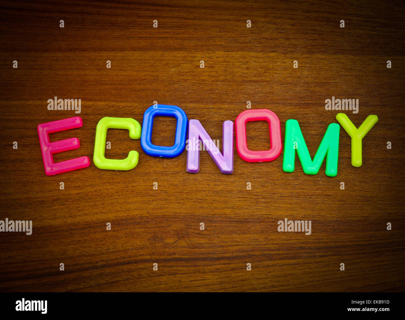 Economy in colorful toy letters on wood background Stock Photo - Alamy