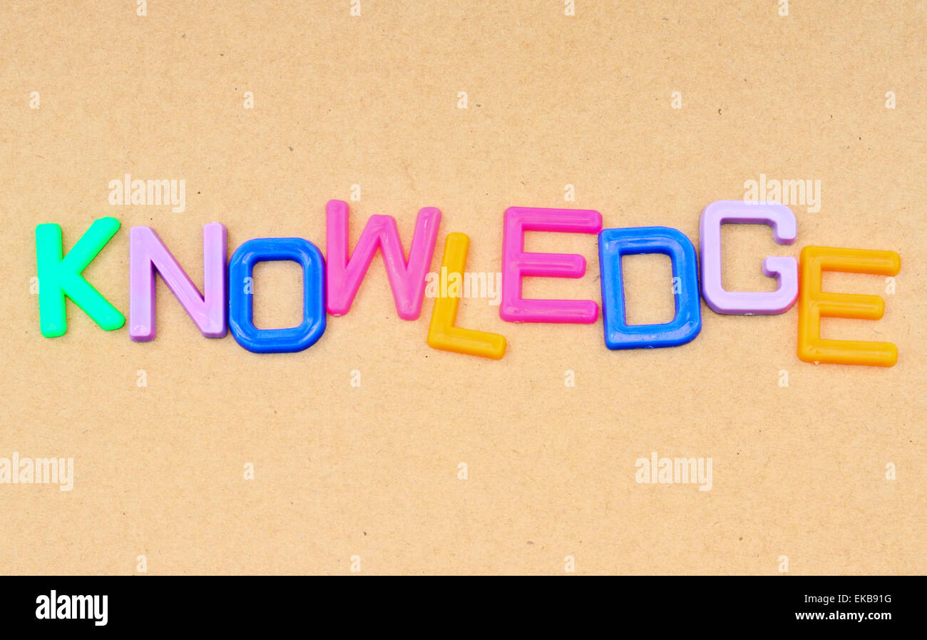 Knowledge in colorful toy letters on paper background Stock Photo - Alamy