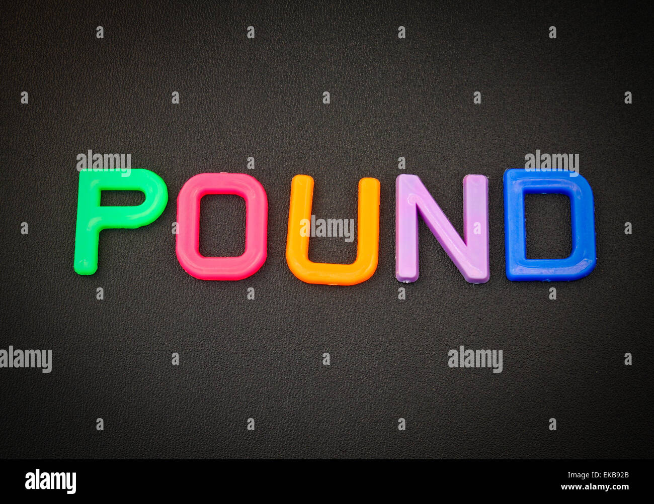 Pound in colorful toy letters on black background Stock Photo - Alamy