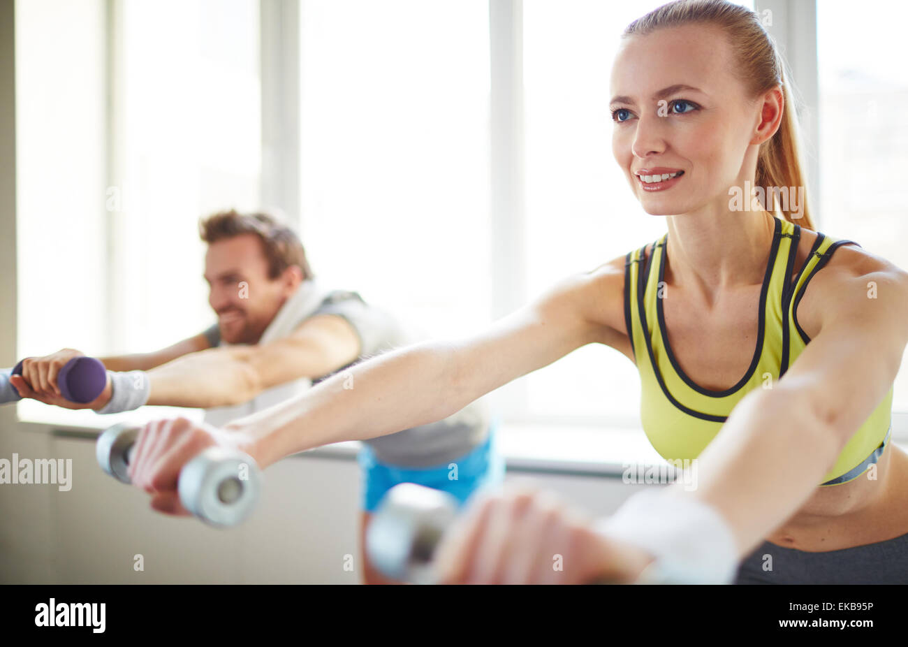 Young woman exercising in gym Stock Photo - Alamy