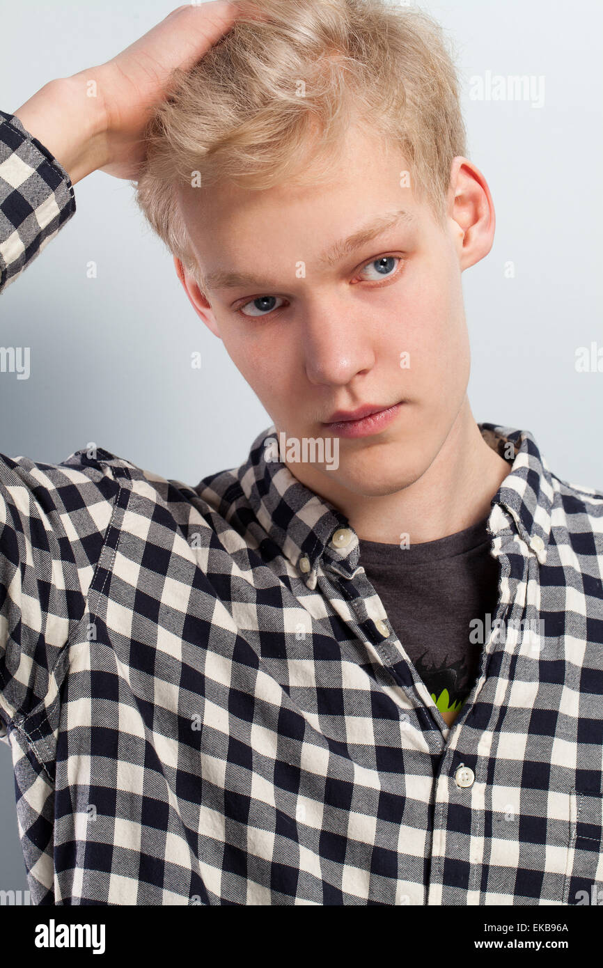 Young handsome guy with hand on head Stock Photo - Alamy