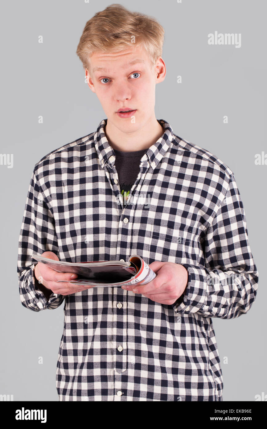 Young handsome guy with journal Stock Photo - Alamy