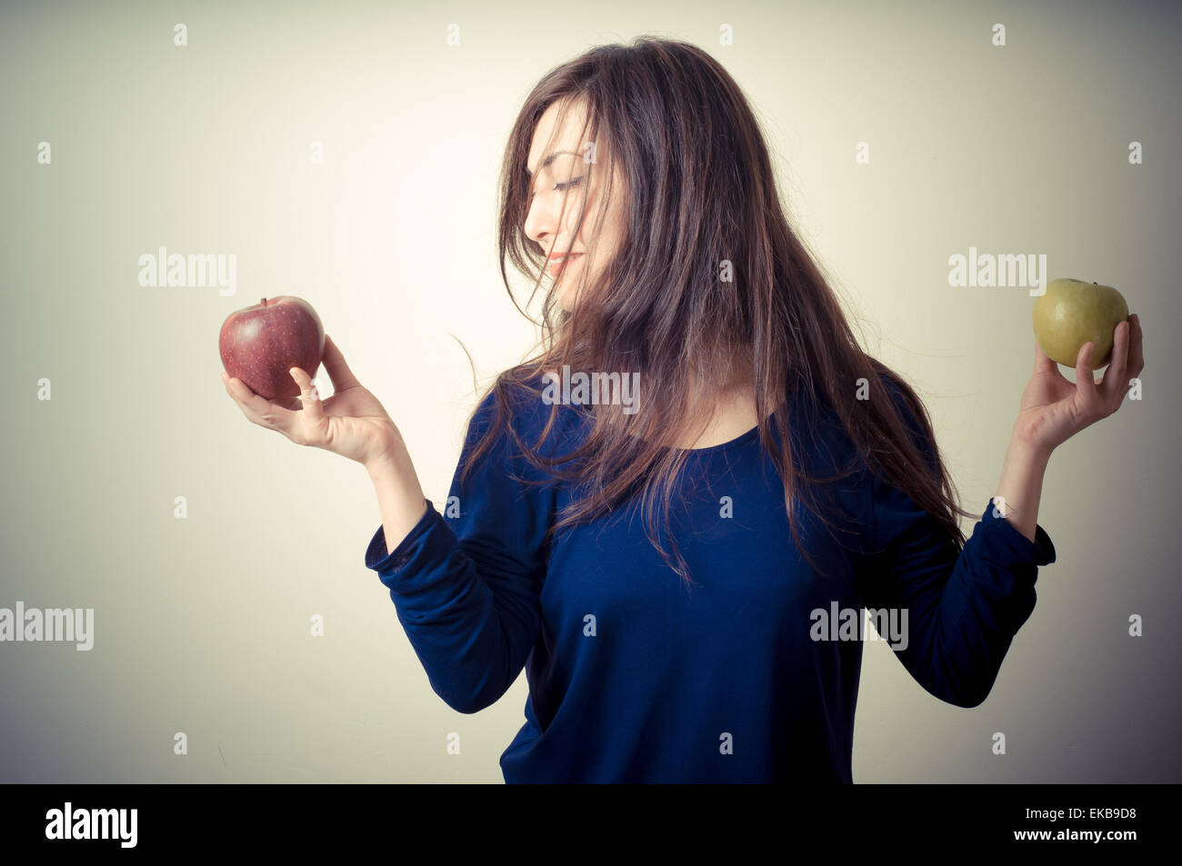 beautiful woman choosing red or yellow apples Stock Photo - Alamy